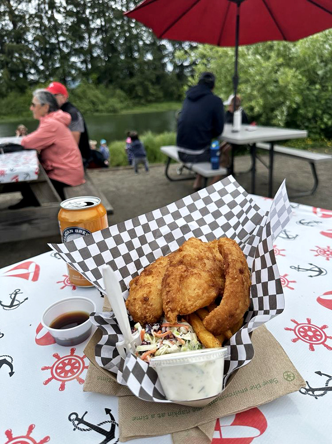 The holy trinity of coastal dining: crispy halibut, golden fries, and that legendary coleslaw, all enjoyed with Oregon's finest canned refreshment.