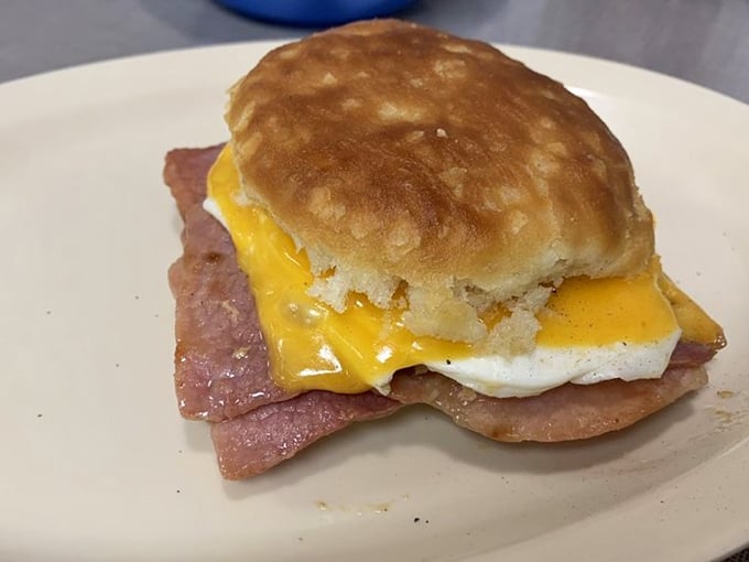 The holy trinity of breakfast: golden biscuit, perfectly fried egg, and country ham. Simple math that equals pure morning bliss.
