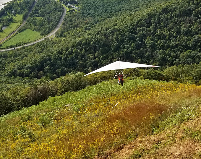 Some people look at mountains and think, "I'd like to jump off that." Hang gliders at Hyner View prove courage and insanity often share the same launch pad.