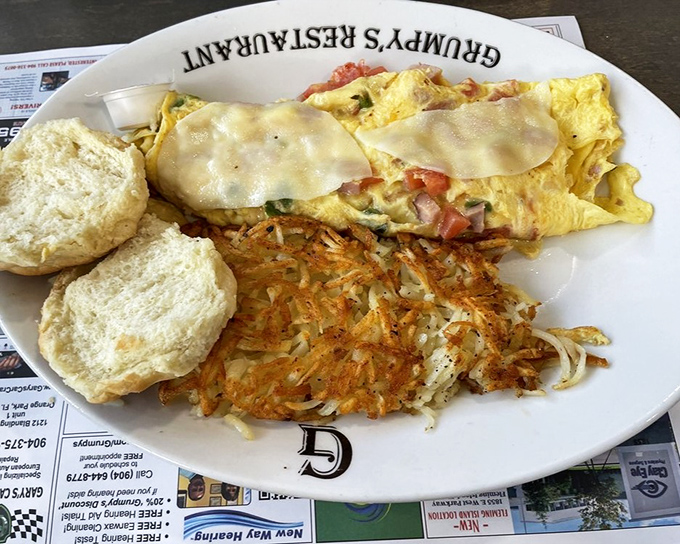 Not just an omelet, but a morning masterpiece. Perfectly executed eggs blanketing colorful fillings, with hash browns so crispy they deserve their own fan club.