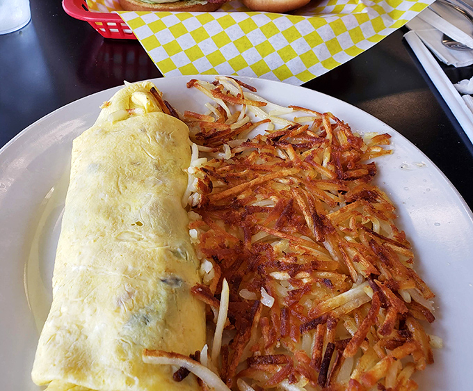 The perfect omelet doesn't exi— Wait, yes it does. Golden, fluffy, and paired with hash browns crisped to mathematical perfection.