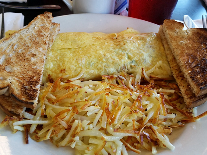 The perfect omelet doesn't exi&mdash; Oh wait, there it is, nestled beside hash browns so perfectly crispy they make that satisfying crunch with every bite.