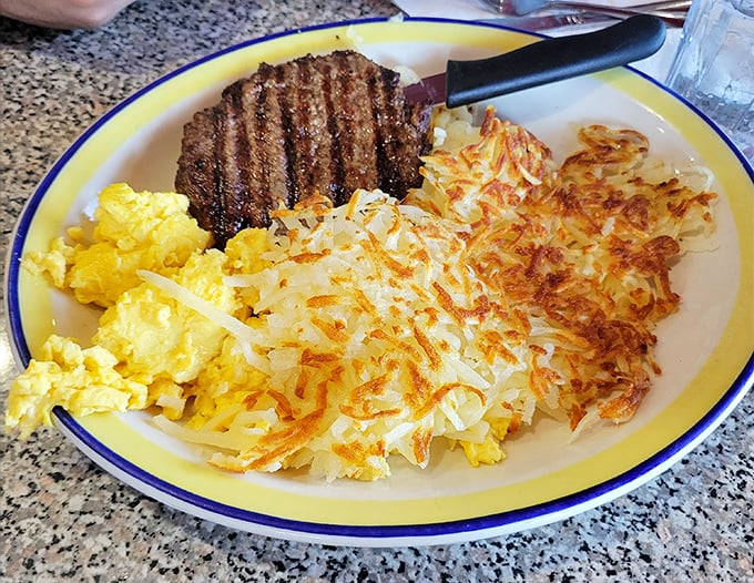 Breakfast of champions: a steak with perfect grill marks sharing the plate with eggs and hashbrowns crisped to golden perfection.