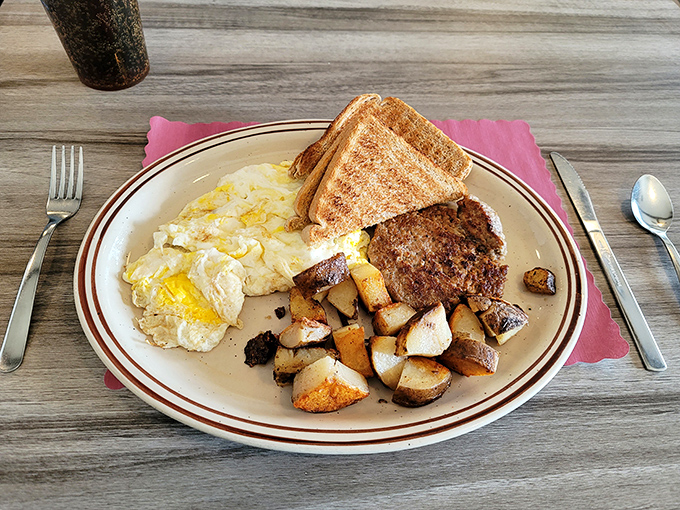 Breakfast platters that mean business! Golden-crisp home fries, eggs with perfectly runny yolks, and toast waiting for its butter bath&mdash;morning glory on a classic diner plate.