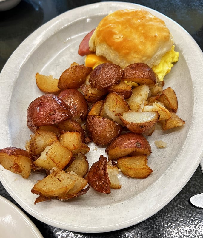 These home fries aren't just cooked, they're transformed &ndash; crispy-edged, perfectly seasoned potato chunks escorting a magnificent breakfast sandwich to greatness.