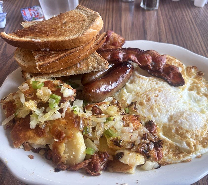 This isn't just breakfast; it's edible therapy&mdash;crispy potatoes mingling with eggs while toast stands by, ready for yolk-dipping duty.