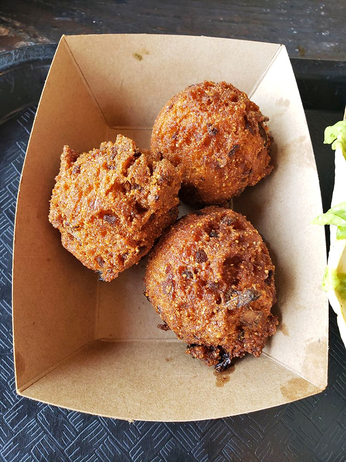 Hush puppies so perfectly golden they should come with a warning label. These crispy orbs of cornmeal joy might cause involuntary food moans.