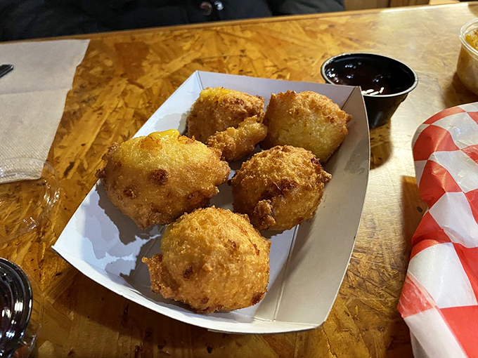 Hush puppies so golden and crispy they practically demand silence while you contemplate their perfect crunch-to-softness ratio. Respect the fritter.
