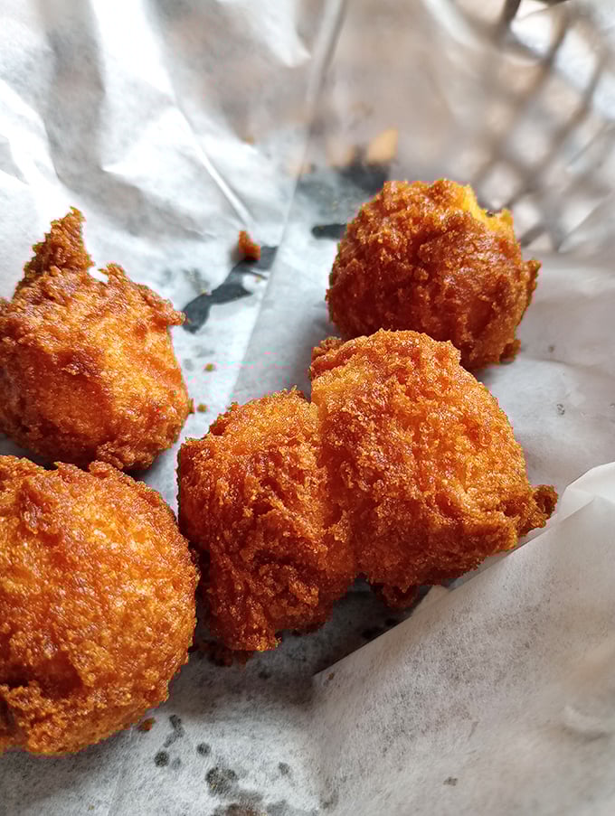 Golden-brown hush puppies that crunch like nature's perfect snack food. Whoever invented these deserves a national holiday.