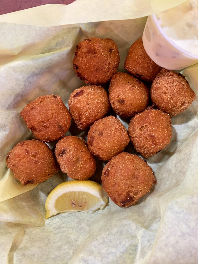 These golden-brown hush puppies aren't just side dishes&mdash;they're crispy cornmeal orbs of joy that demand a squeeze of lemon and complete silence while savoring.