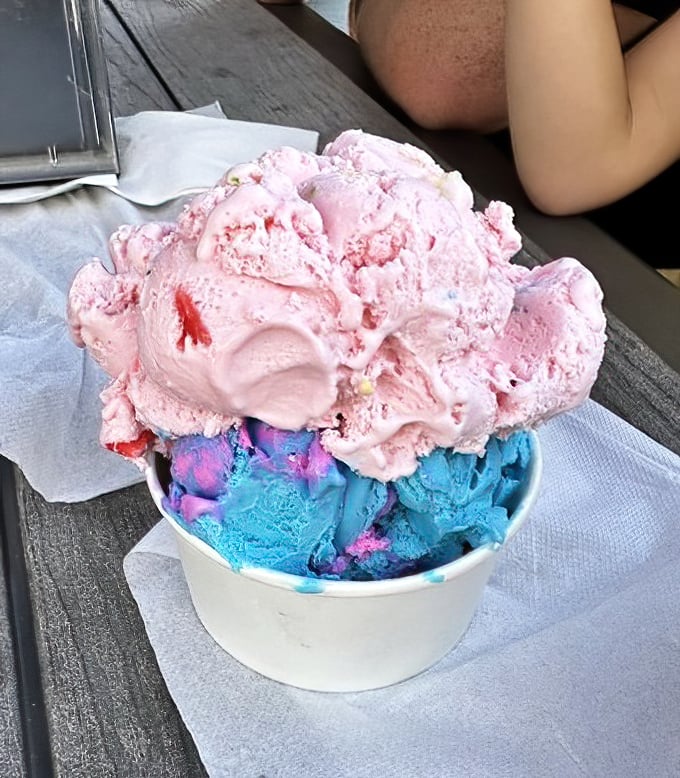 Ice cream that doesn't know the meaning of moderation. Pink and blue scoops stacked with the kind of generosity that makes you feel like you've won something.
