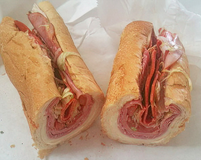 The Italian hoagie, sliced in half to reveal its glorious cross-section, showcases the architectural precision that separates good sandwiches from great ones.