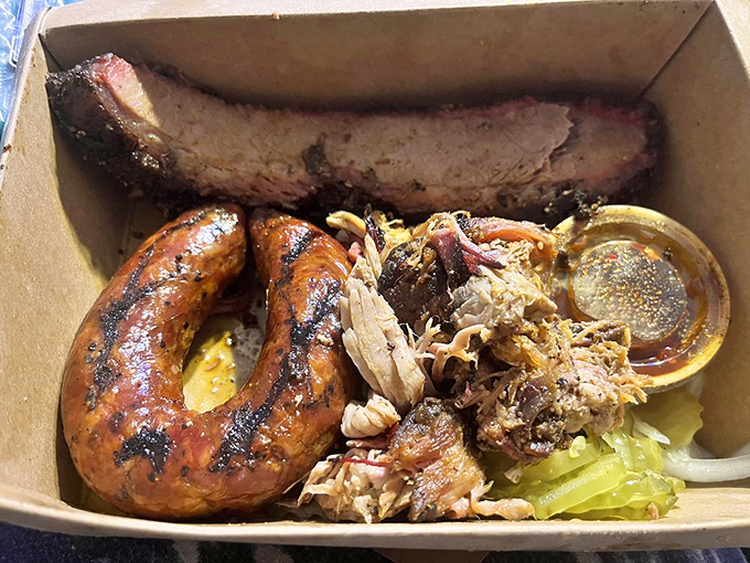 A cardboard container never held such treasure&mdash;sausage with the perfect snap, tender pulled pork, and a rib that's worth fighting over.