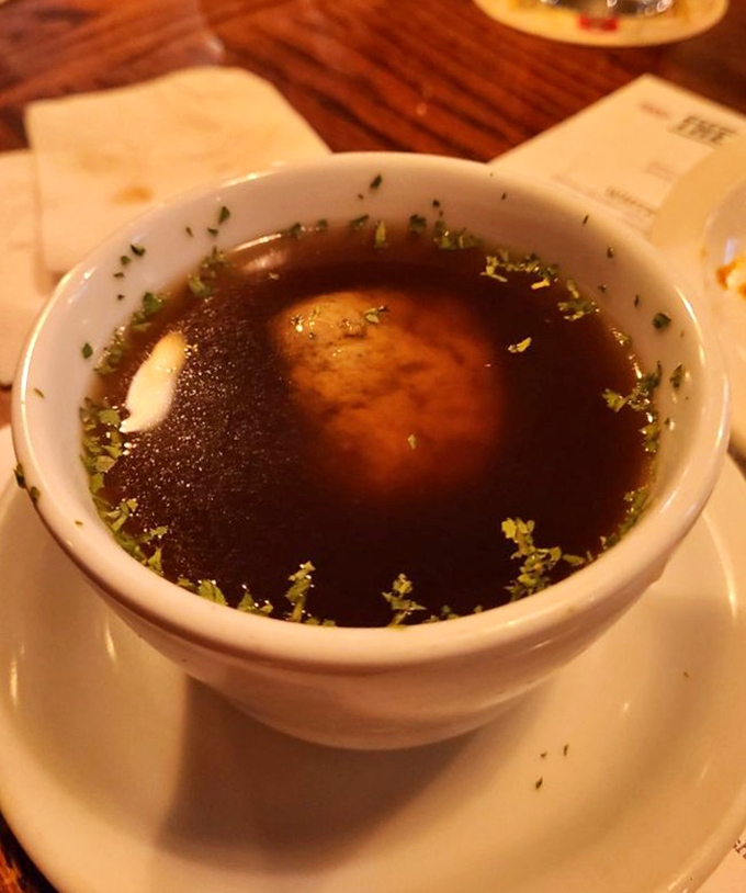 Liver dumpling soup that would make your German grandmother weep with joy—a rich broth cradling a dumpling that's both hearty and delicate.