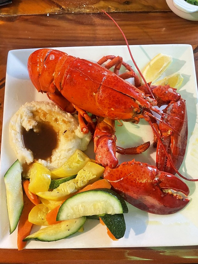 This lobster isn't just dinner&mdash;it's a crimson-clad celebrity on your plate. The stuffed potato and fresh vegetables know they're just supporting actors in this seafood drama.