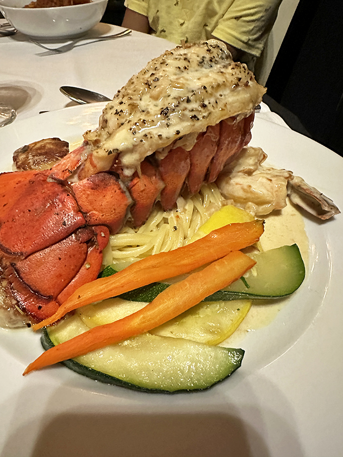 The lobster tail isn't just the star of this plate&mdash;it's the headliner of a culinary concert with fresh vegetables as the perfect supporting act.