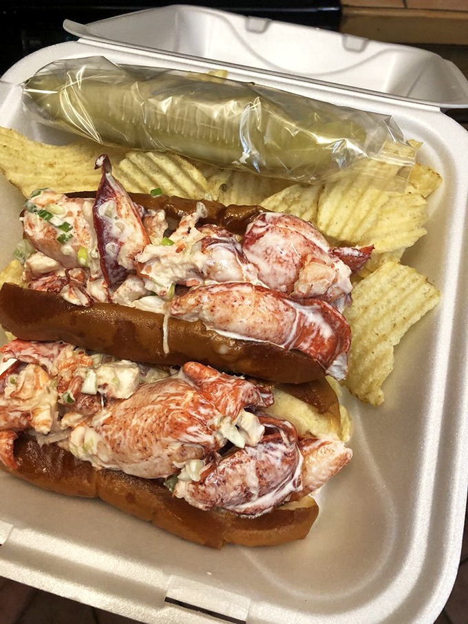 The lobster roll arrives like a seafood celebration&mdash;chunks of sweet meat barely contained by a perfectly toasted bun, with chips standing guard.