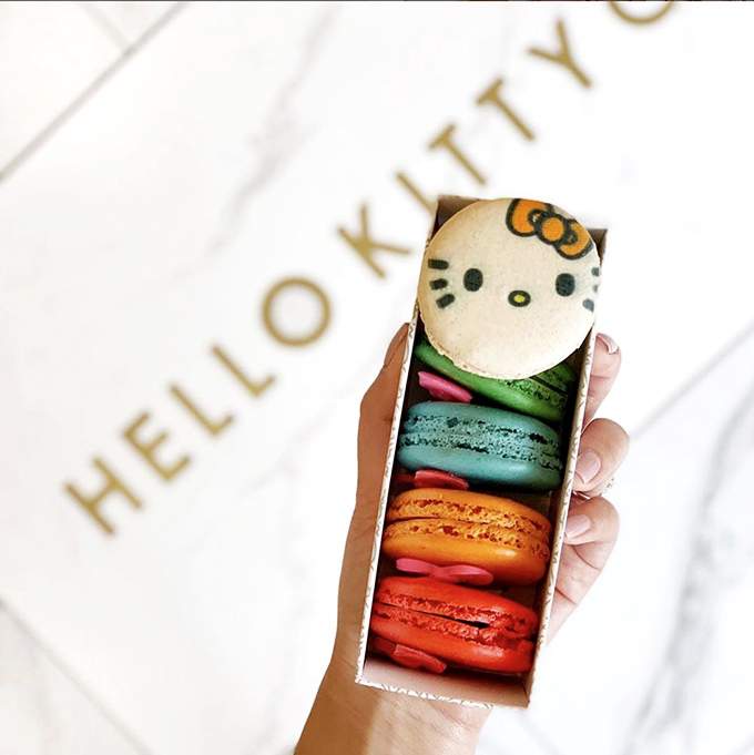 A rainbow of macarons topped with Hello Kitty herself – proof that sometimes the most delicious things in life are also the most photogenic.