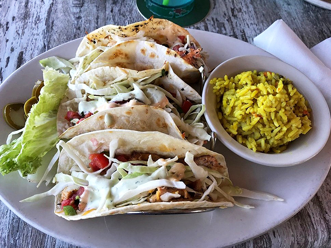 These fish tacos aren't just a meal &ndash; they're a vacation on a plate, complete with sunshine-colored rice that tastes like Florida in every grain.