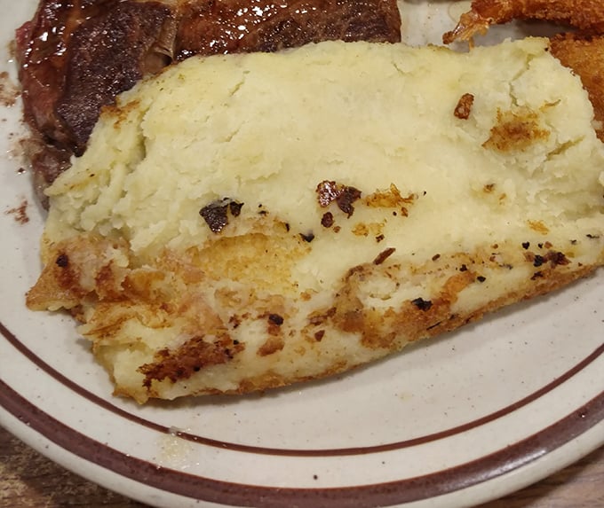 These mashed potatoes aren't just a side dish&mdash;they're a fluffy, buttery mountain waiting for your fork-shaped flag to claim them. Comfort food architecture at its finest.