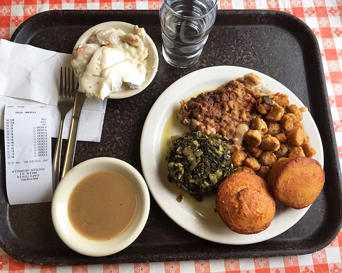 Southern perfection on a plate: tender meat, vibrant greens, golden cornbread, and sides that deserve their own fan club.