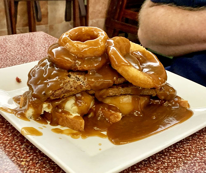 Behold the Tower of Power&mdash;donuts and French toast stacked higher than your weekend expectations, drowning gloriously in caramel sauce.