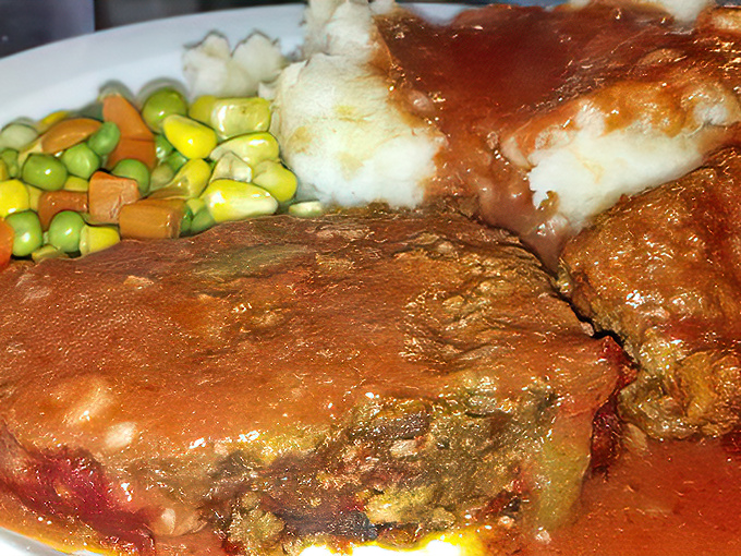 This meatloaf isn't trying to reinvent itself with fancy ingredients. It's confident in its classic status, swimming gloriously in savory gravy.