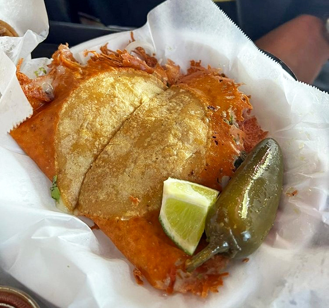 The Mulita Aporkalypse arrives like a crispy, cheese-laden postcard from heaven, complete with a lime wedge and jalape&ntilde;o exclamation point.