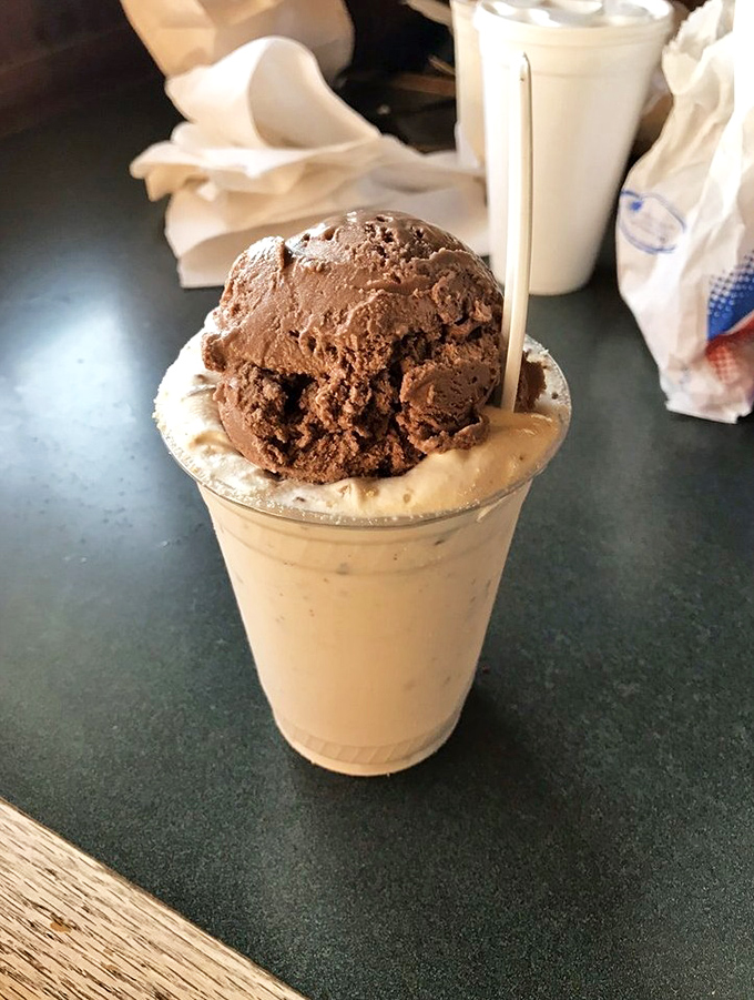 This isn't just a milkshake; it's a structural marvel with chocolate ice cream standing proudly atop a foundation of creamy goodness.