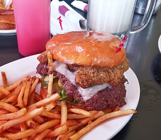 This isn't just a burger &ndash; it's a skyscraper of deliciousness that requires both strategic planning and a healthy appetite to conquer.