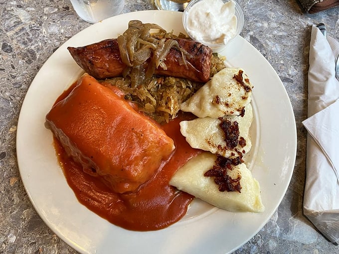 A Polish platter that would make Warsaw proud &ndash; golabki (stuffed cabbage) nestled alongside pierogi and kielbasa, all bathed in rich tomato sauce that demands to be sopped up.