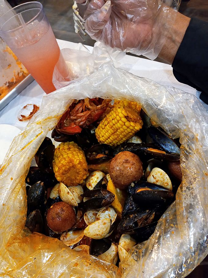 The seafood boil bag&mdash;nature's most perfect delivery system. Corn, potatoes, and shellfish swimming in seasoned broth like they're attending the world's tastiest pool party.