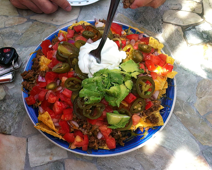 Nachos that could feed a family or one very determined Texan. A colorful fiesta of toppings that demands to be shared.