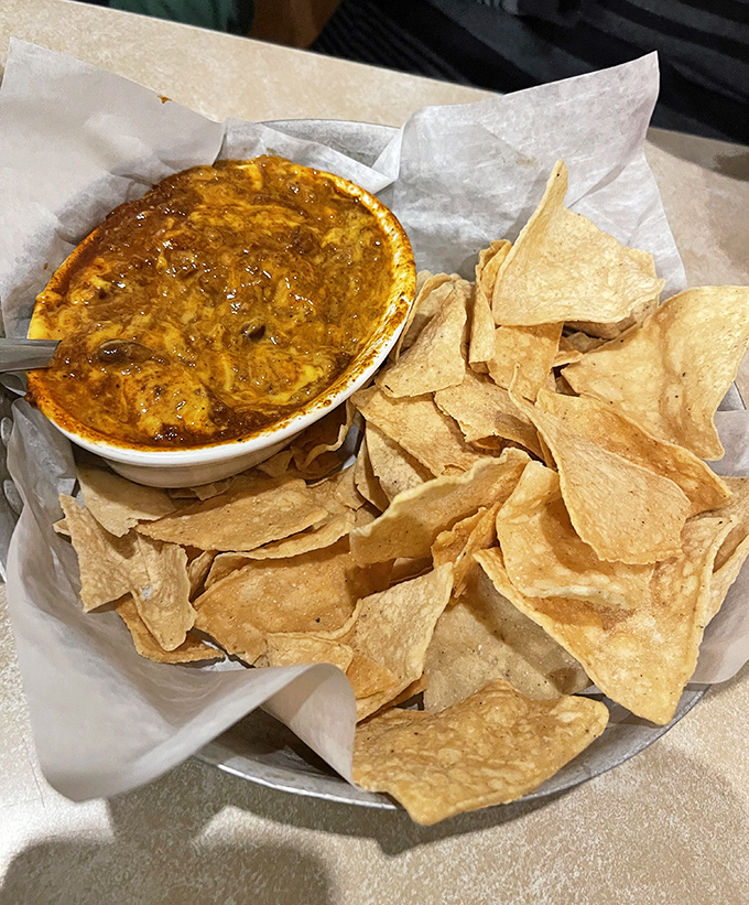 Kroll's Con Queso pairs homemade chili with Wisconsin cheese, creating a dip so addictive you'll find yourself negotiating for the last chip.
