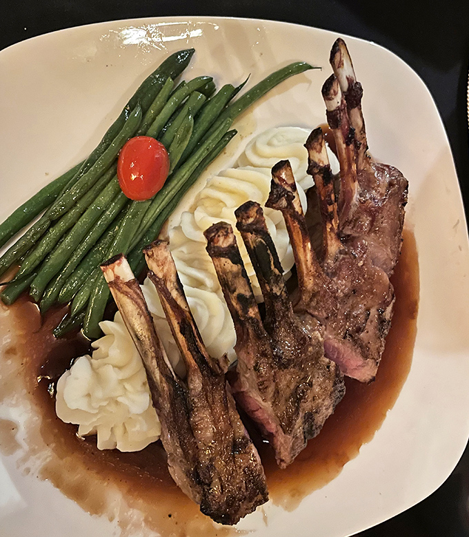 The rack of lamb stands at attention like prison guards of old, but tastes infinitely better than anything served in the mess hall.