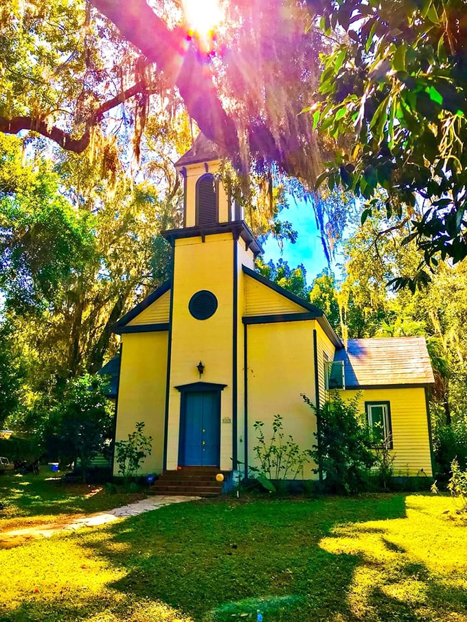 The sunshine-yellow Baptist church glows like a beacon among the moss-draped oaks, its simple architecture speaking volumes about old Florida faith.