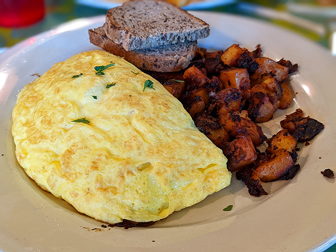 A perfect omelet that's somehow both fluffy and substantial, paired with home fries that achieved the holy grail: crispy outside, tender inside.