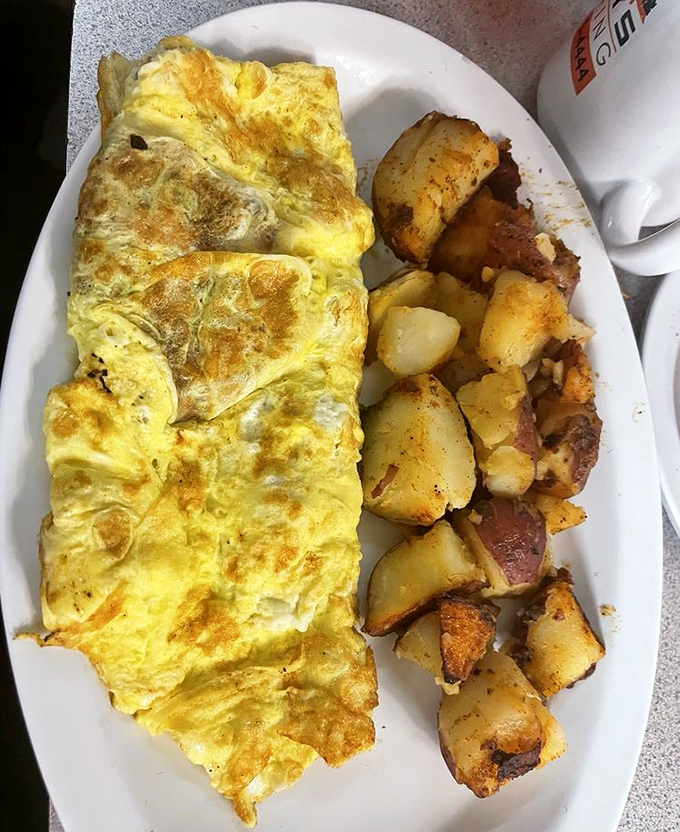 This omelet doesn't just fill the plate&mdash;it conquers it. Paired with those seasoned potatoes, it's the breakfast equivalent of winning the lottery.