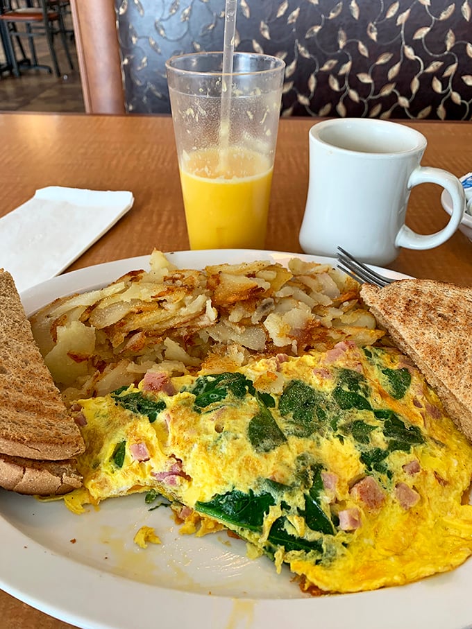 This spinach and ham omelet isn't just breakfast&mdash;it's edible artwork. Paired with crispy home fries and whole wheat toast for morning perfection.