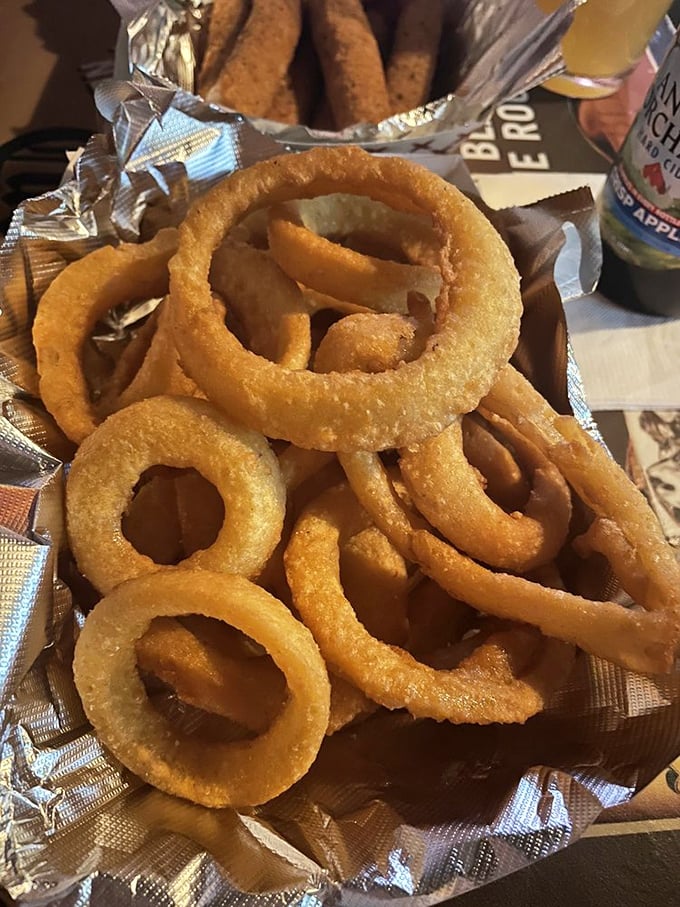 Onion rings that achieve the impossible: a crispy exterior that doesn't slide off with the first bite. These golden halos deserve their own fan club.