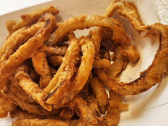 These aren't just onion rings; they're golden halos of crispy perfection that make you question why vegetables ever bothered growing any other way.