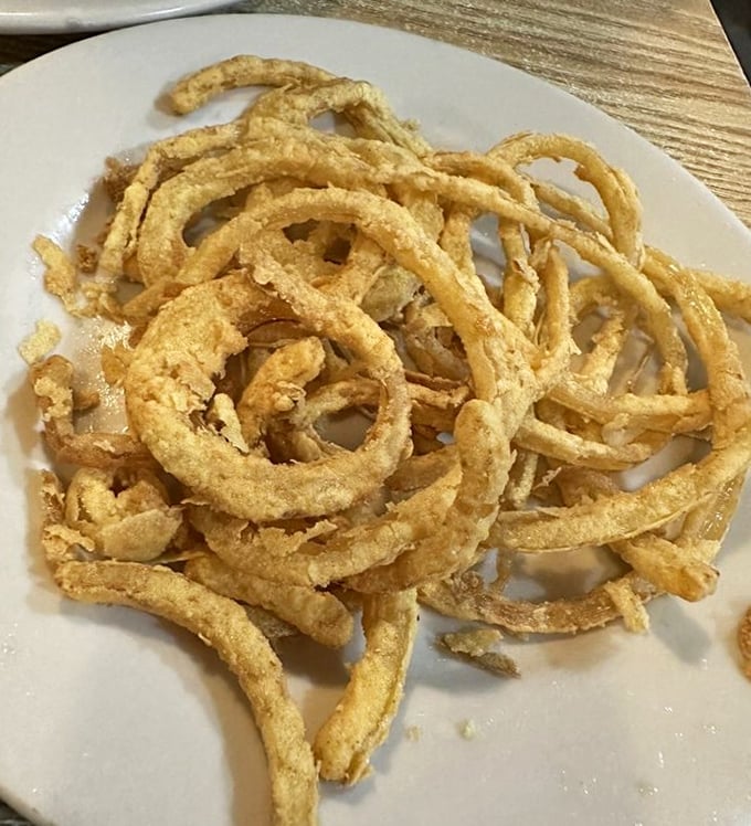 These aren't just onion rings&mdash;they're crispy golden halos that deserve their own special place in the fried food hall of fame.