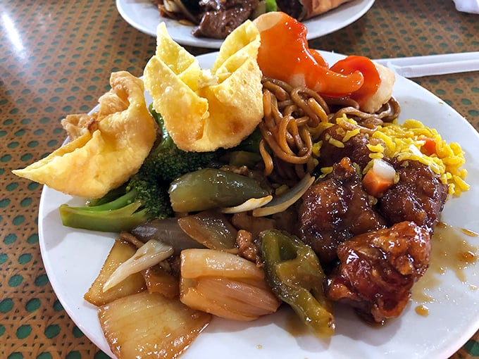 A plate that tells a story: crispy orange chicken, vibrant vegetables, and fried rice playing supporting roles in perfect harmony.