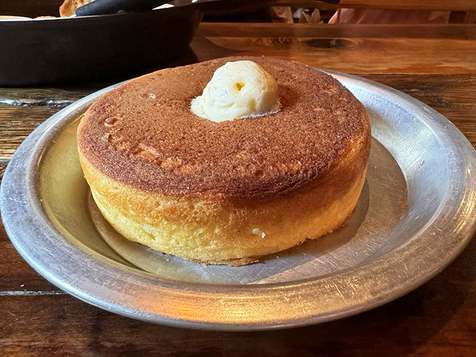 This isn't just a pancake&mdash;it's a golden disk of joy with a melting butter hat, standing tall enough to make regular flapjacks feel inadequate.