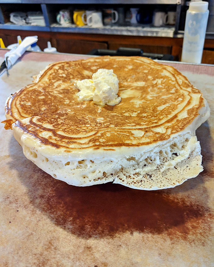 Pancakes so fluffy they could double as pillows. That dollop of butter slowly melting into golden perfection is breakfast poetry in motion.