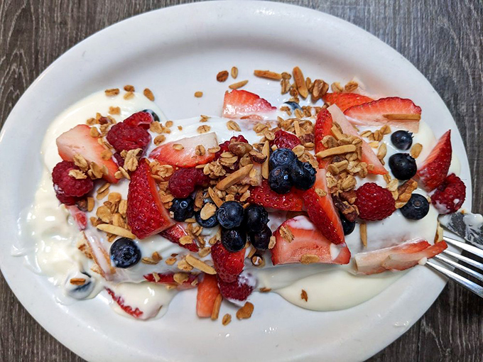 Nature's candy store on a plate. Fresh berries and homemade granola transform yogurt from simple breakfast to morning celebration.