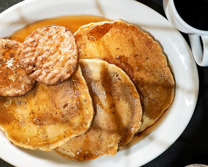 Golden pancakes with a perfectly grilled sausage patty&mdash;the kind of breakfast that makes you want to cancel your morning plans and order a second round.