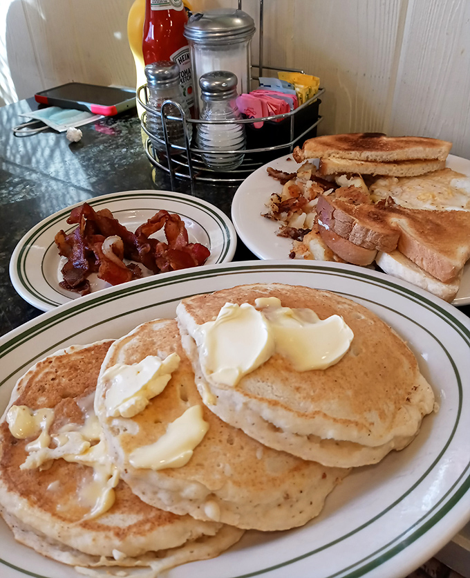 Pancakes with melting butter pools that could make a grown adult weep with joy. Paired with that crispy bacon? Breakfast nirvana achieved.