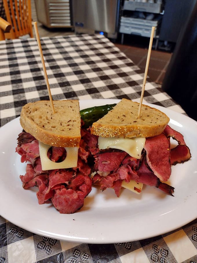 This isn't just a sandwich; it's a skyscraper of pastrami with Swiss cheese windows and pickle doormen. Architecture you can eat!