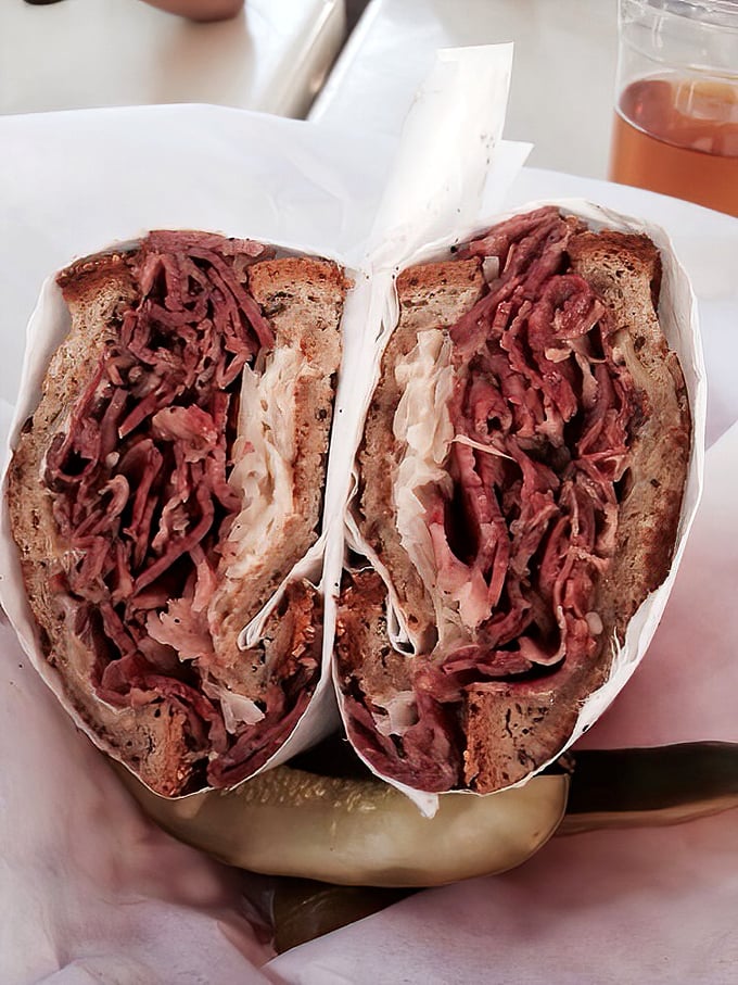 This isn't just a sandwich; it's a pastrami masterpiece that makes you wonder why you've wasted time on lesser lunch options.